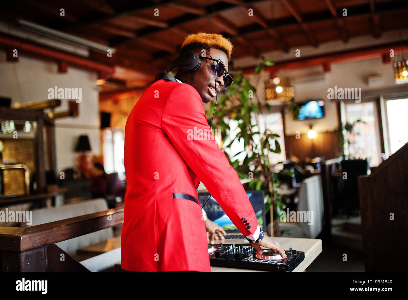 Fashion african american man model DJ at red suit with dj controller ...