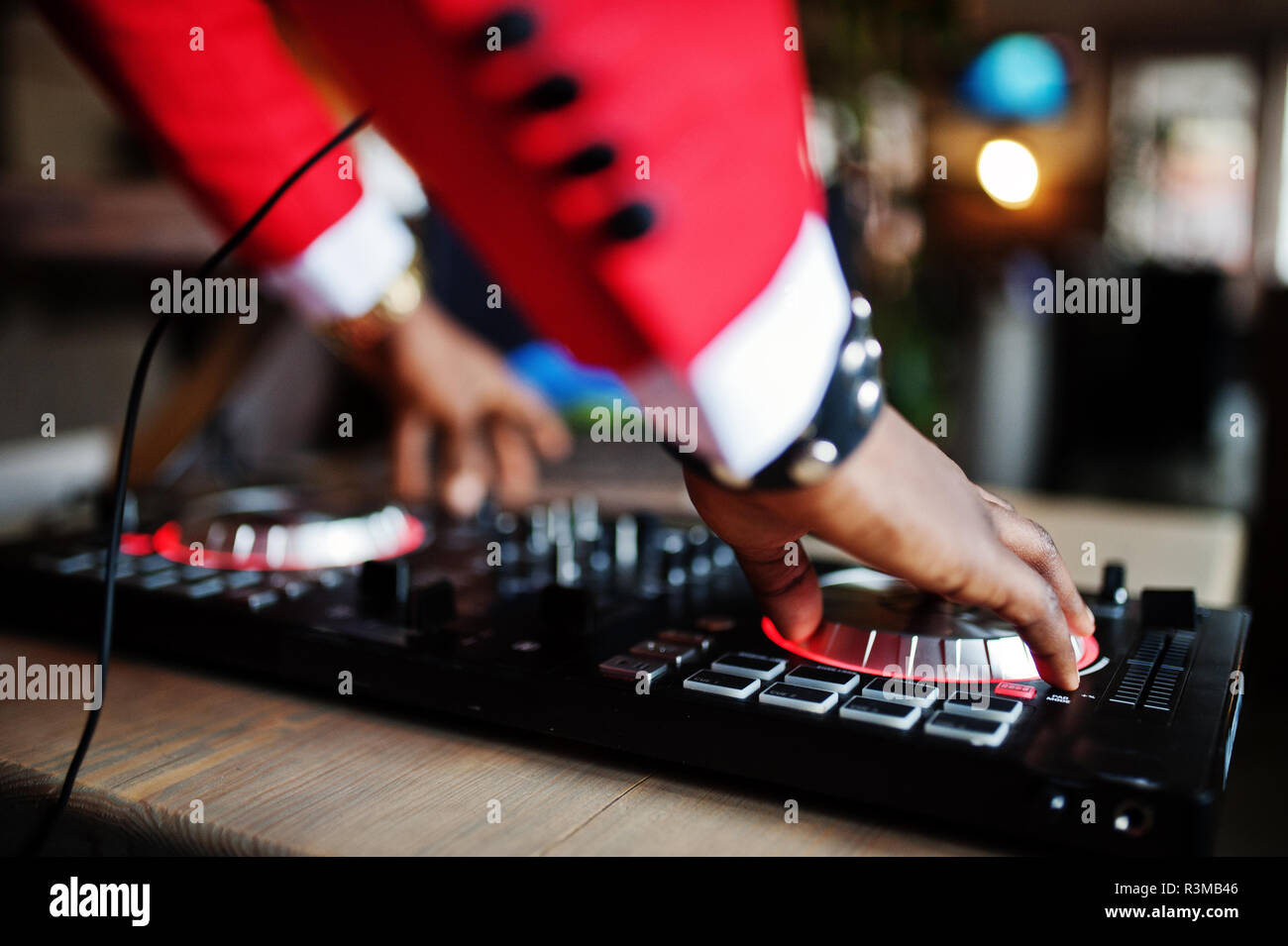 Hands of fashion african american man model DJ at red suit with dj ...