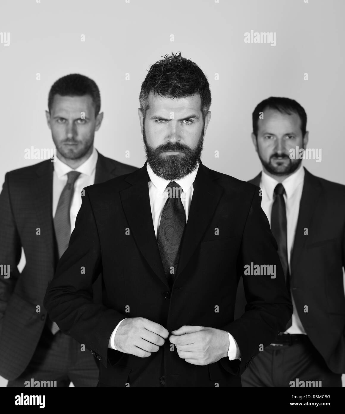 Executives stand for company on light grey background. Deal or argument ...