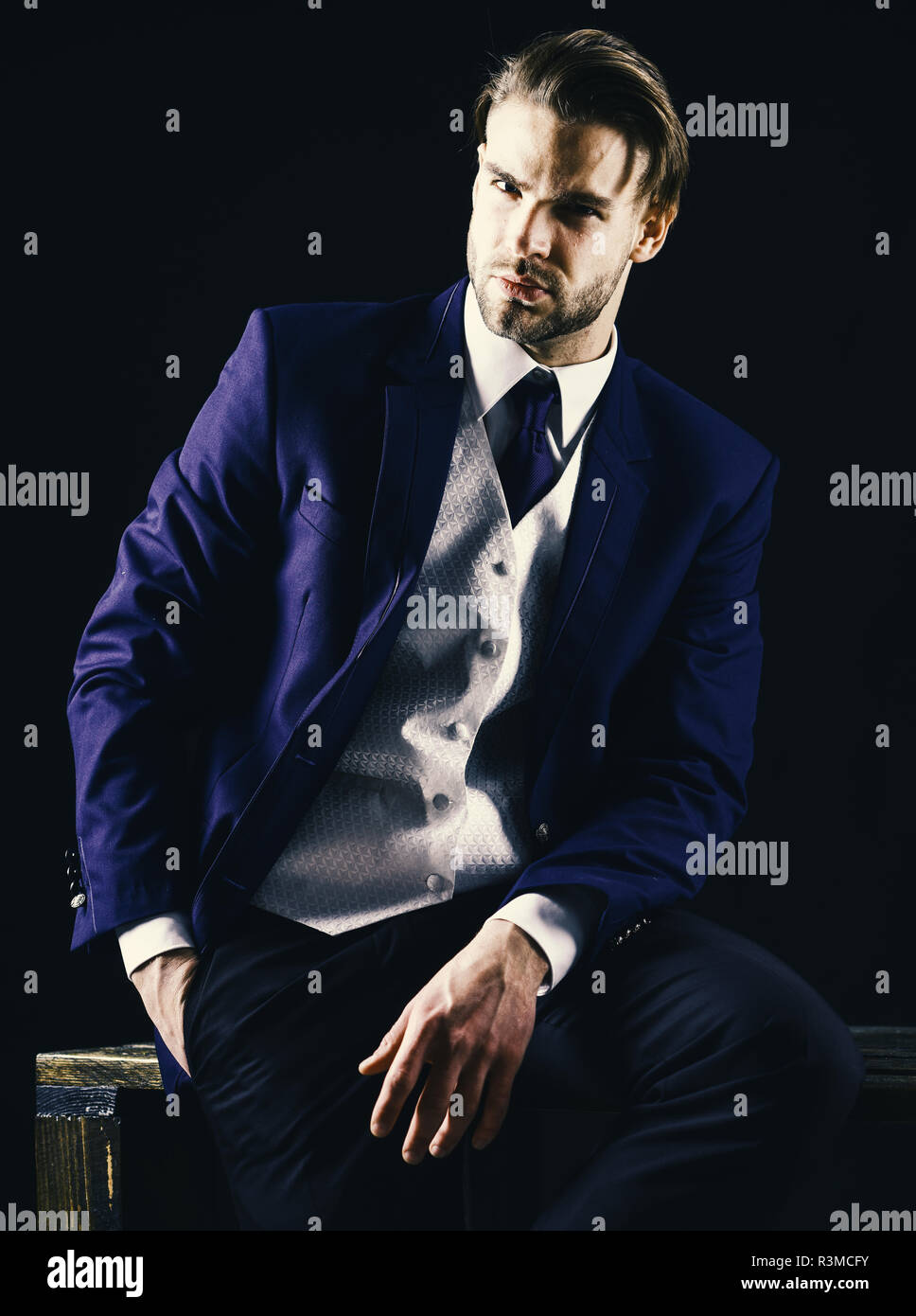 Businessman In Formal Wear With Unshaven Face And Stylish Haircut Looks