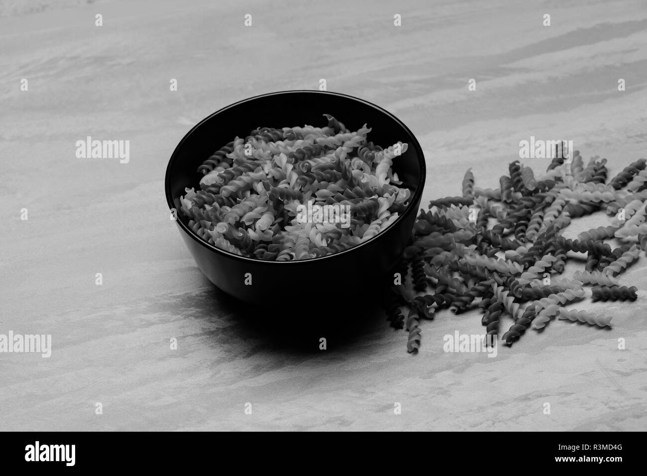 delicious colorful Italian pasta in black ceramic plate on grey ...