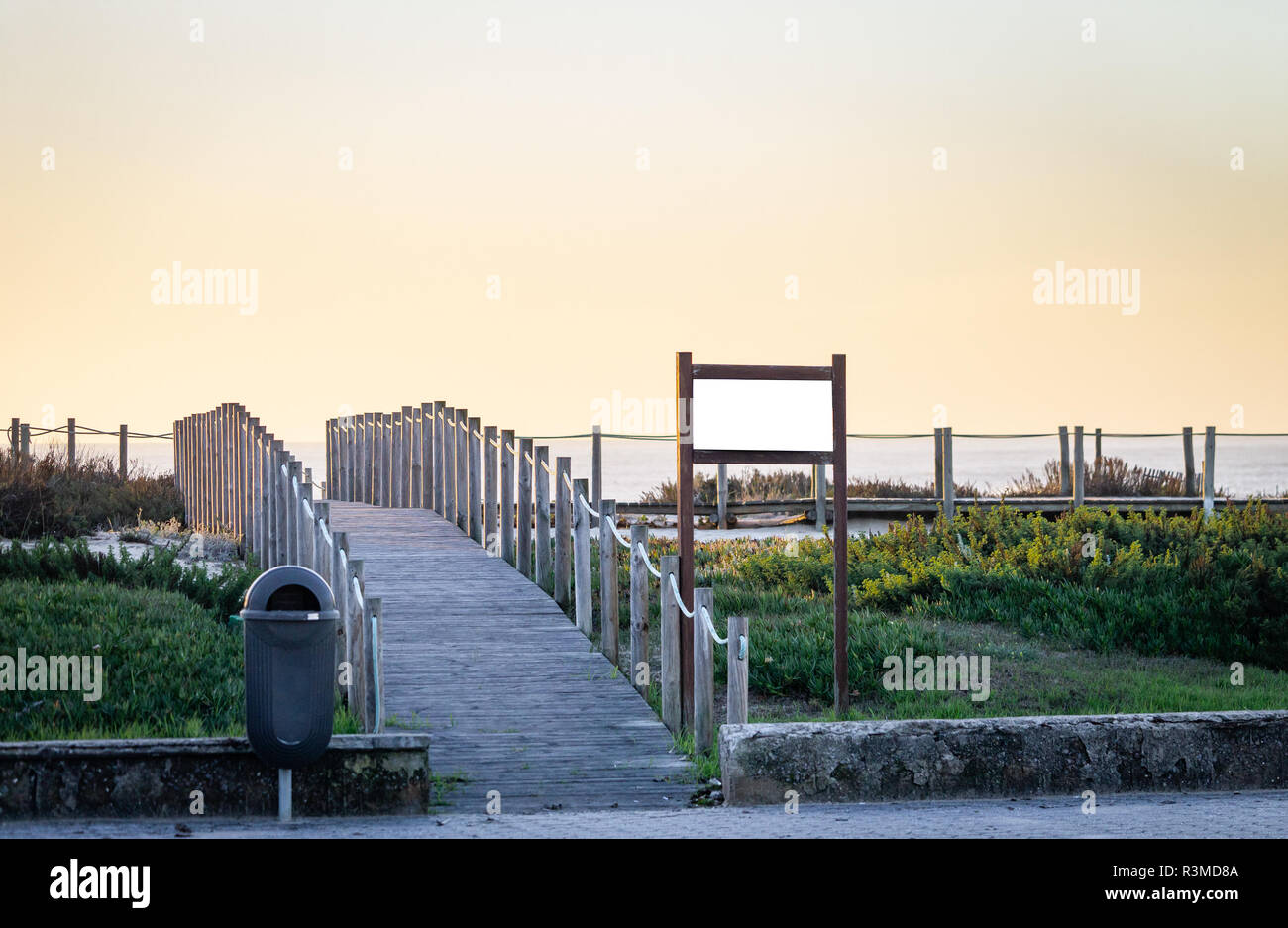 Small advertisement wooden billboard mockup near wooden boardwalk ...
