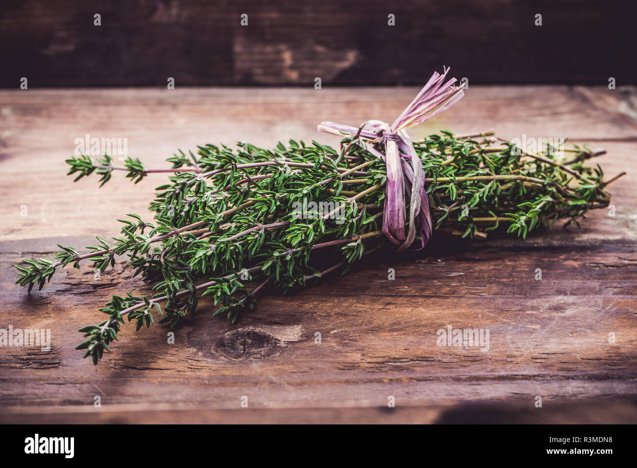 Fresh thyme bundled on a background Stock Photo - Alamy