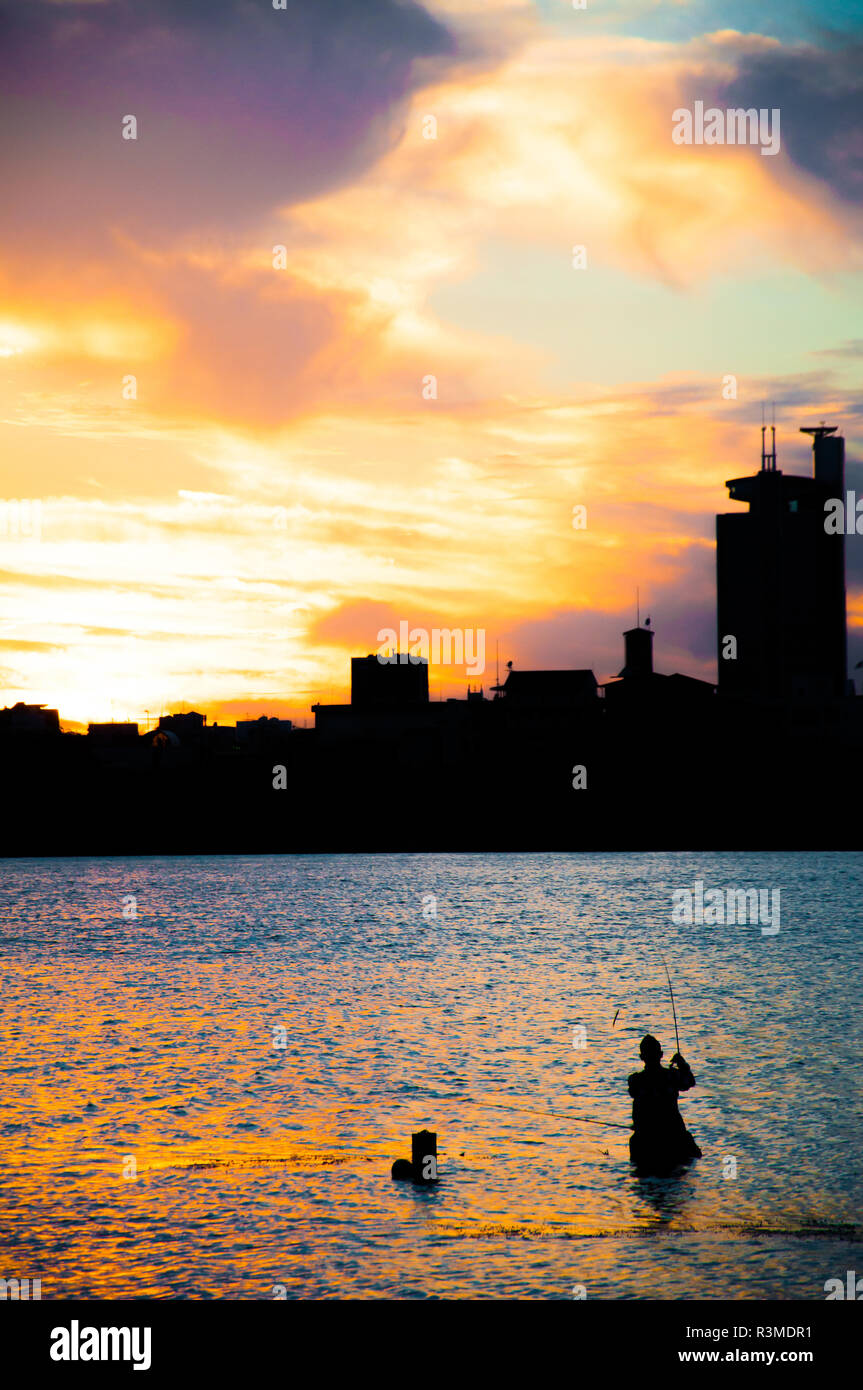 Fisherman silhouette in action spinning hi-res stock photography and ...