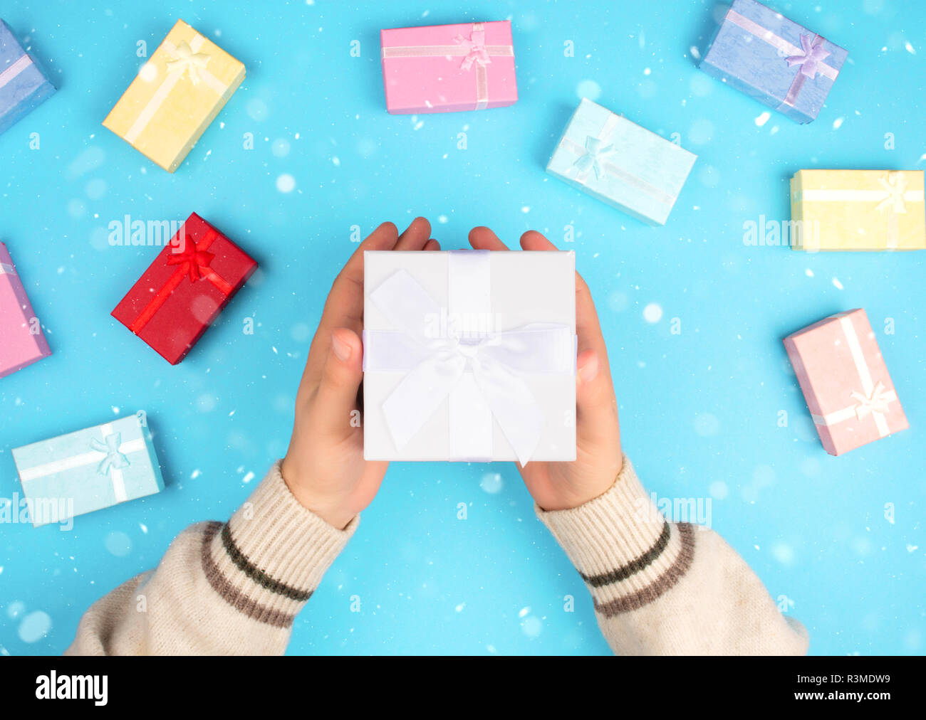 Hands holding a small box with a gift Stock Photo - Alamy