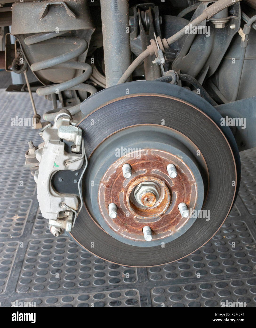 A close up view of the rusted brake disks and pads of a all wheel drive ...