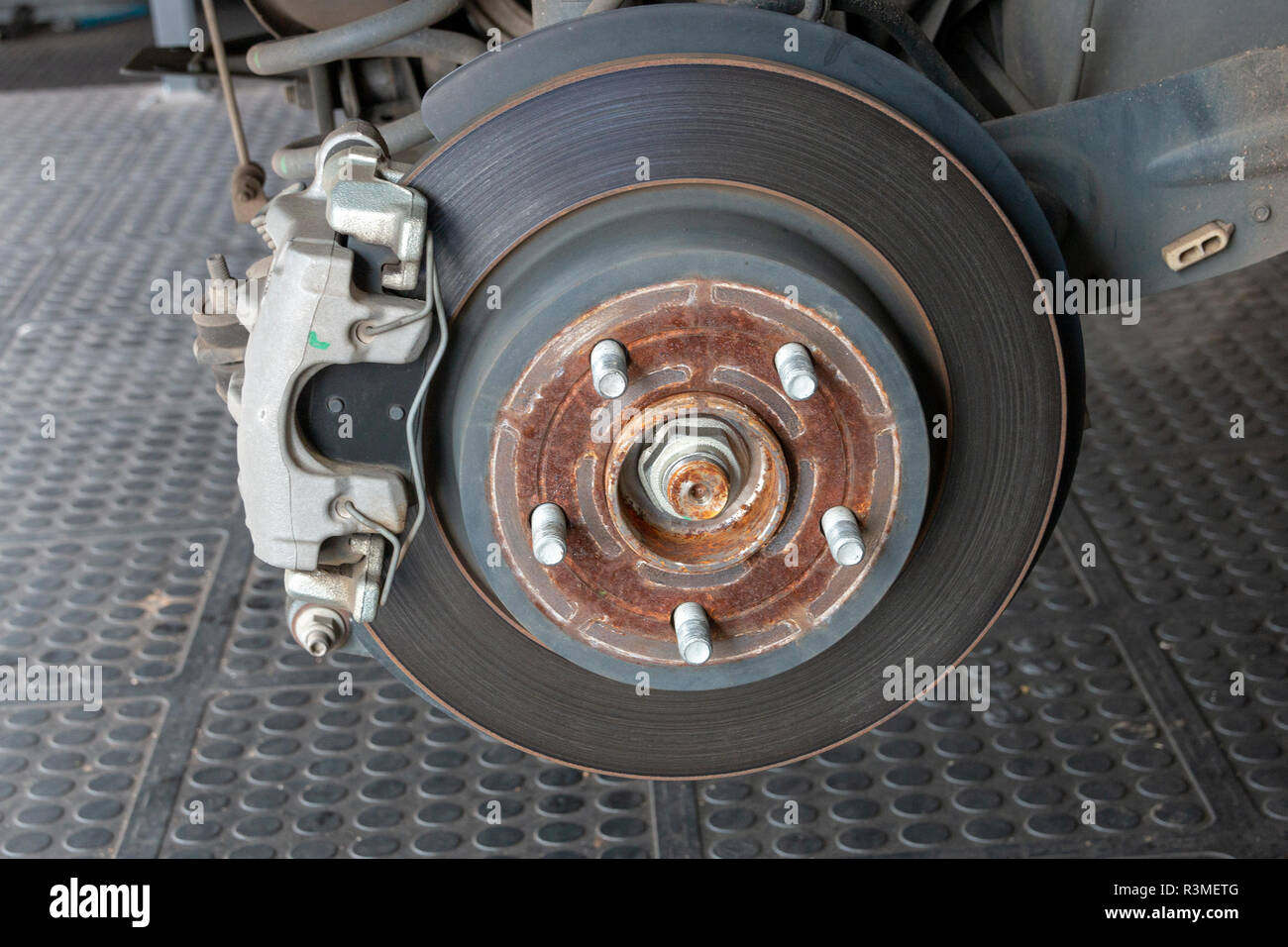 A close up view of the rusted brake disks and pads of a all wheel drive ...