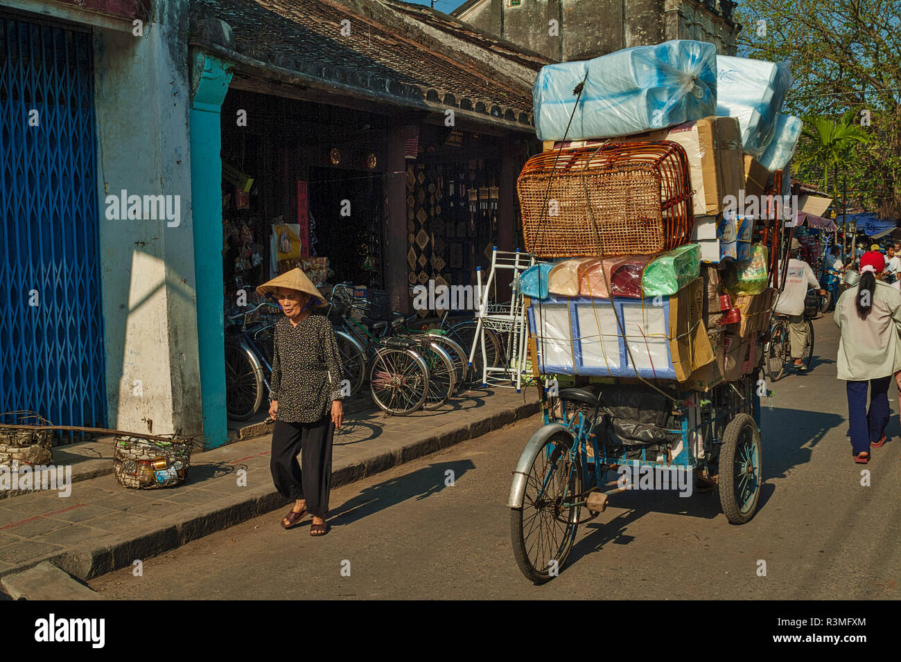 heavily loaded rickshaw on a street in Hoi An, Vietnam Stock Photo - Alamy