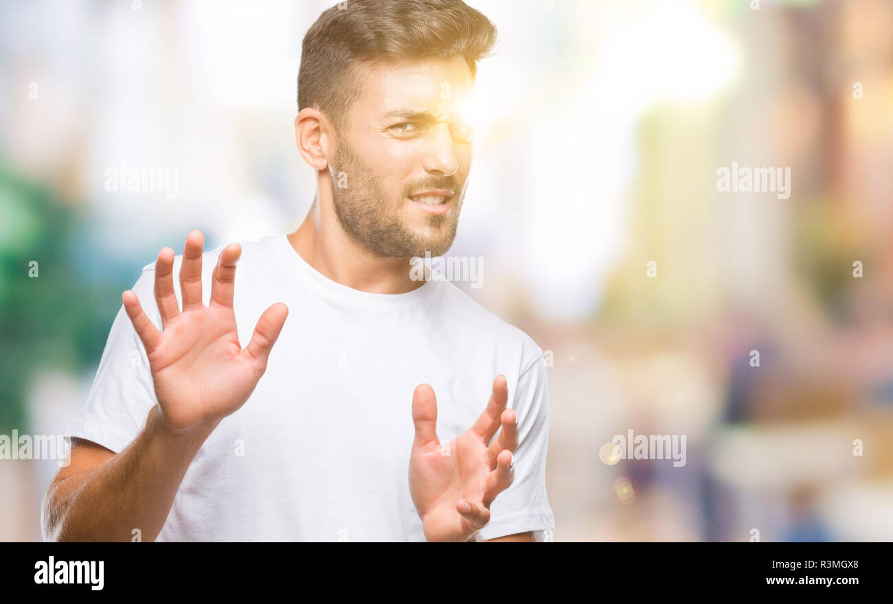 Young handsome man over isolated background disgusted expression ...