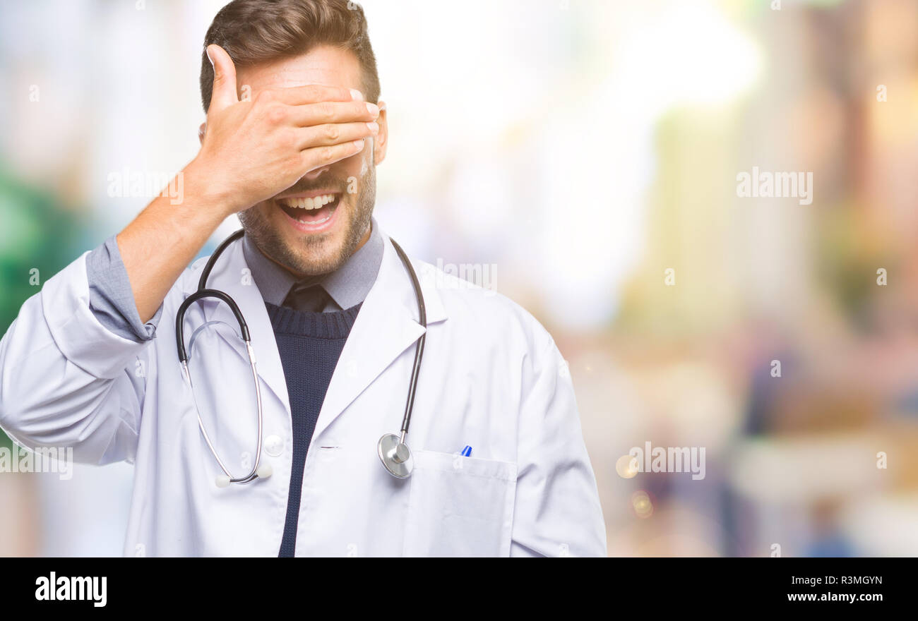 Young handsome doctor man over isolated background smiling and laughing ...
