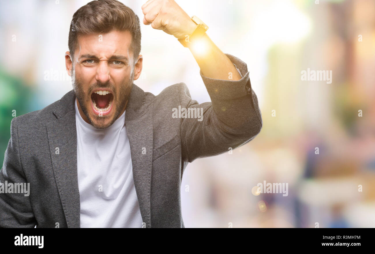 Young handsome business man over isolated background angry and mad ...