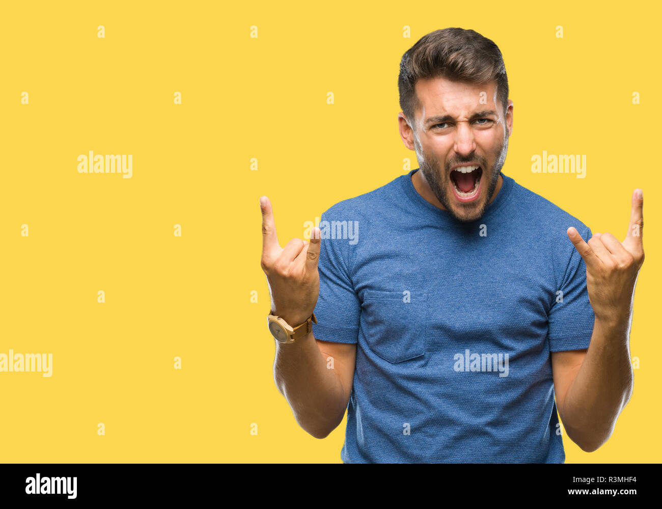 Young handsome man over isolated background shouting with crazy ...