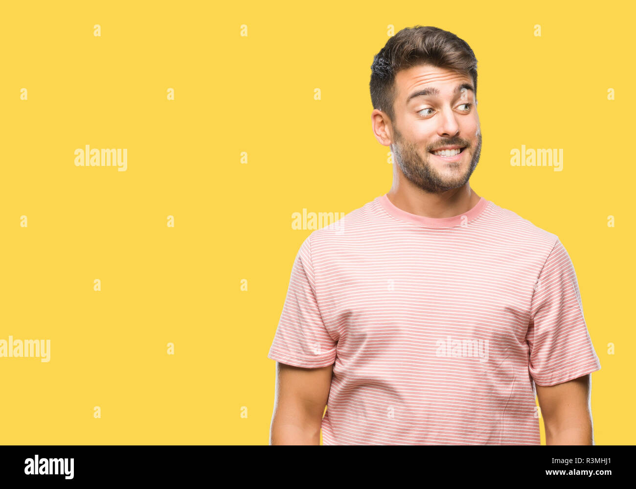 Young handsome man over isolated background smiling looking side and ...