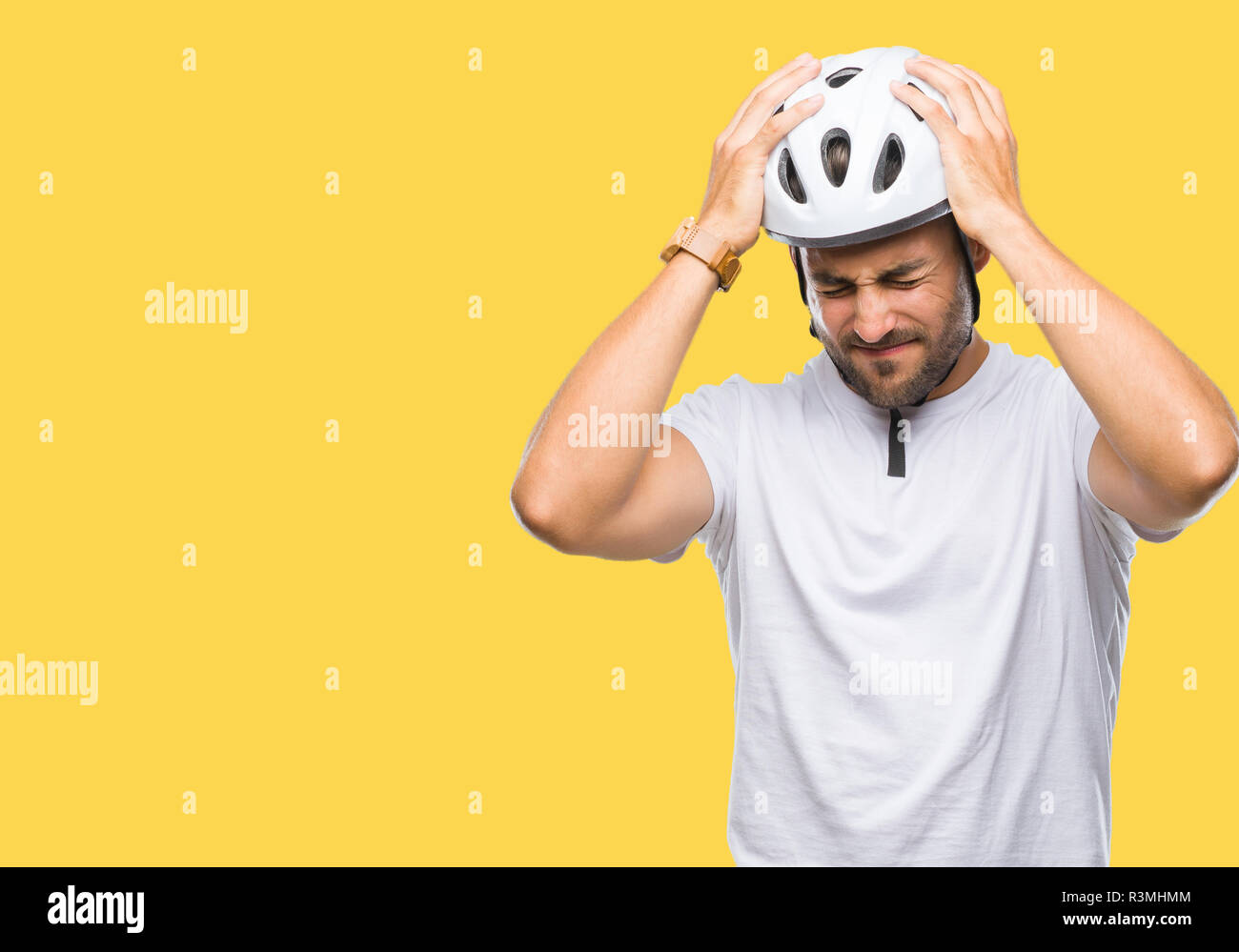 Young handsome man wearing cyclist safety helmet over isolated ...