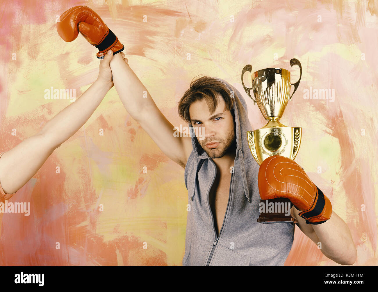 Man with messy hair on colorful background. Boxer with serious face ...