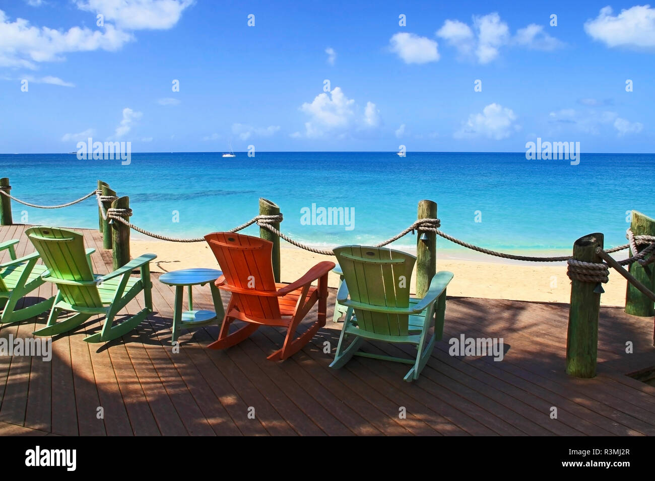 Antigua, Galley Bay. Empty wooden deck chairs along the sandy ...