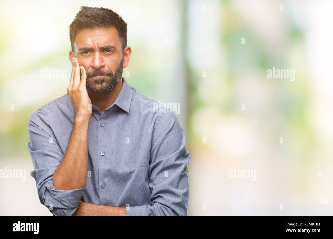 Adult hispanic man over isolated background thinking looking tired and ...