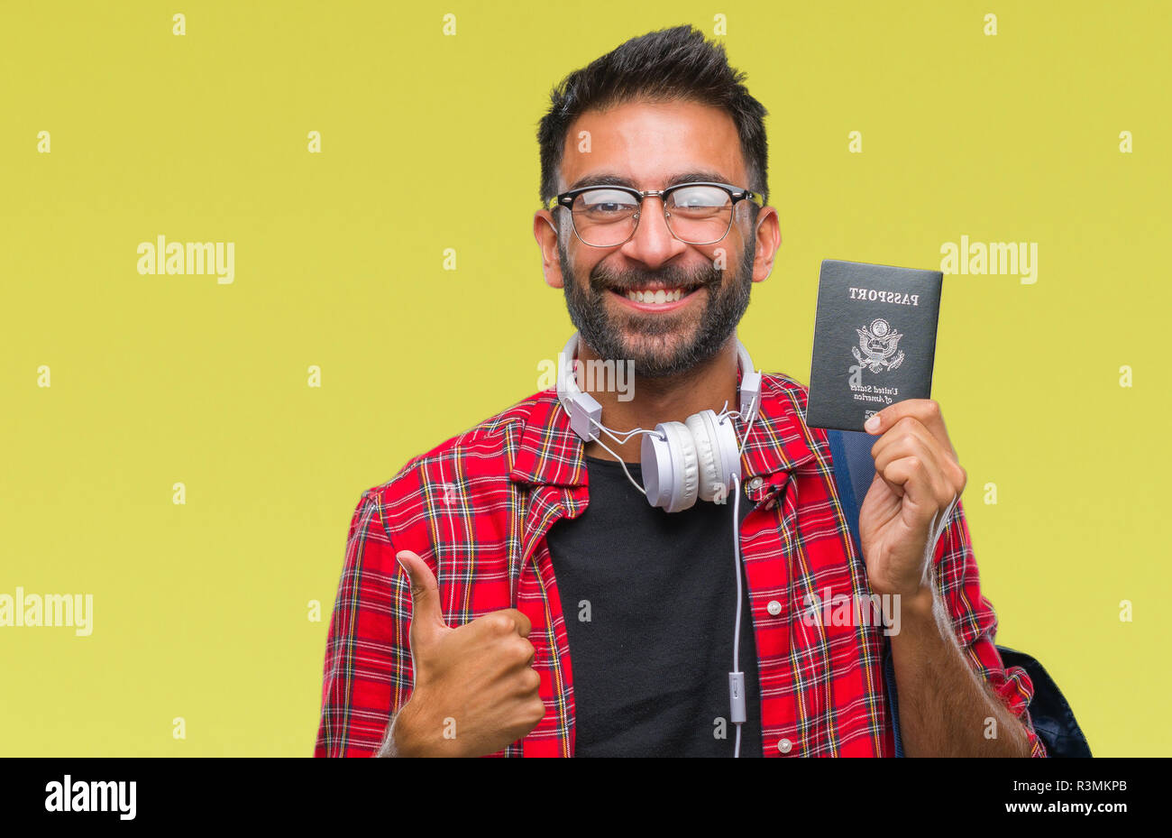 Adult hispanic student man holding passport of america over isolated ...