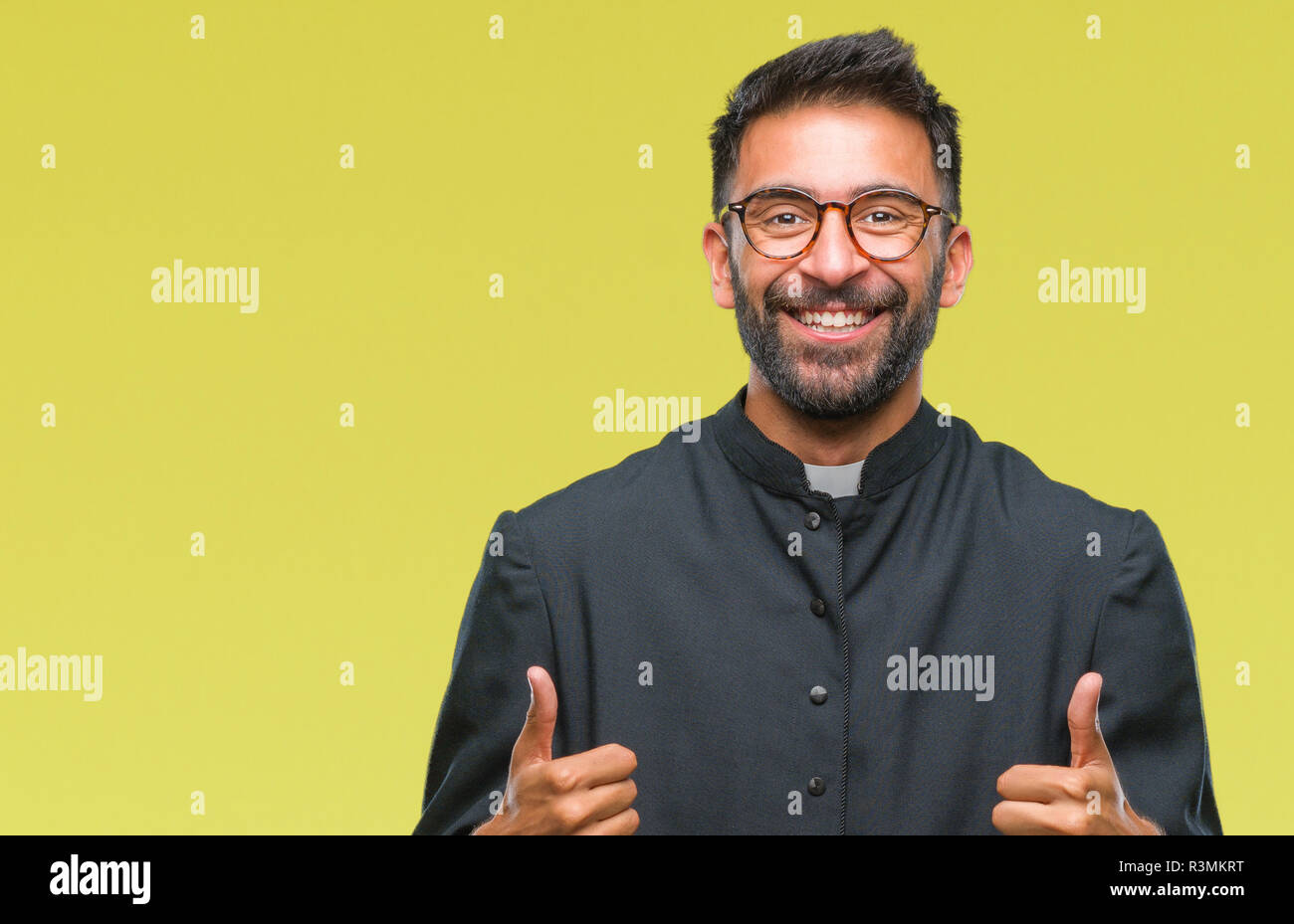 Adult hispanic catholic priest man over isolated background success ...