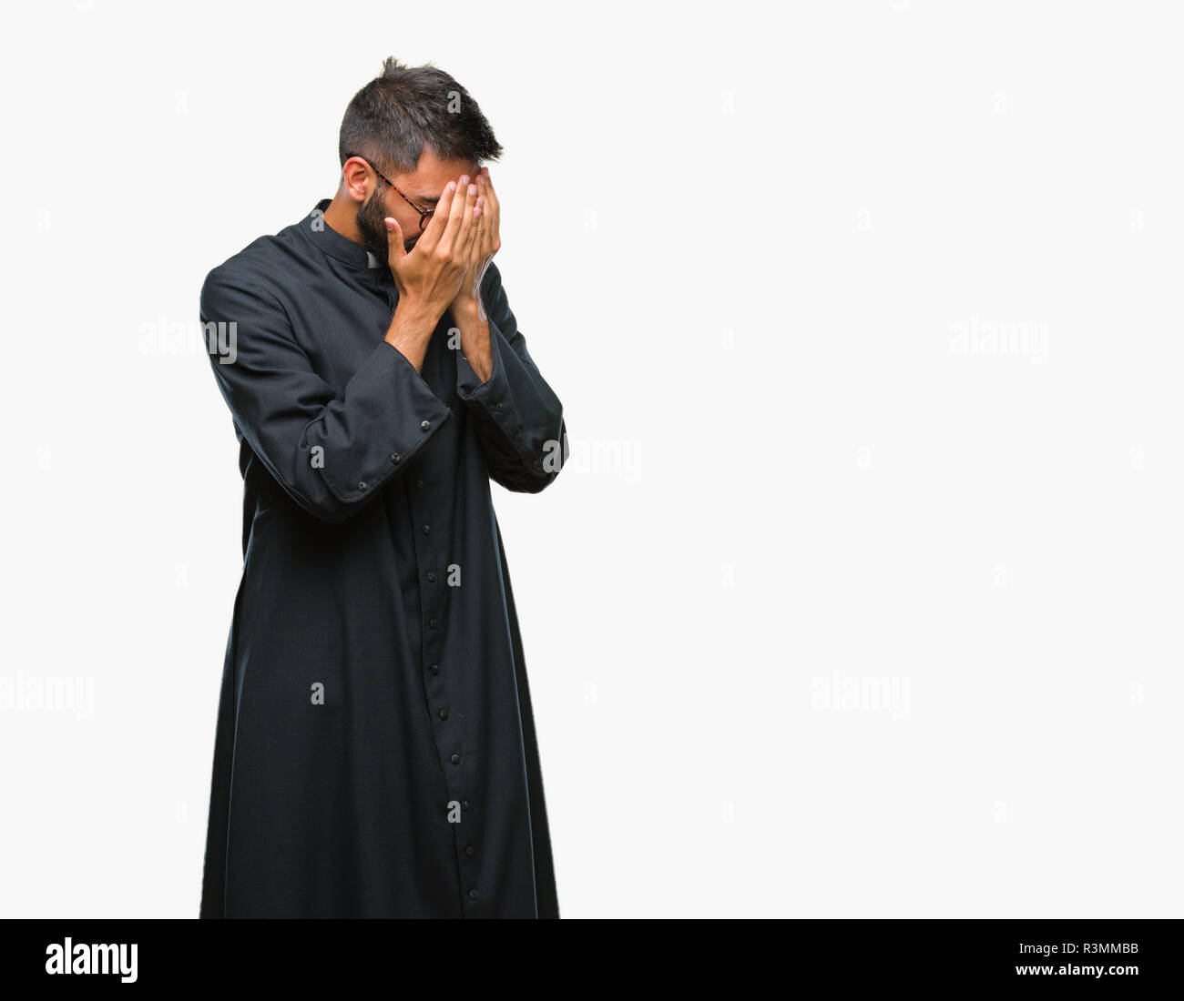 Adult hispanic catholic priest man over isolated background with sad ...