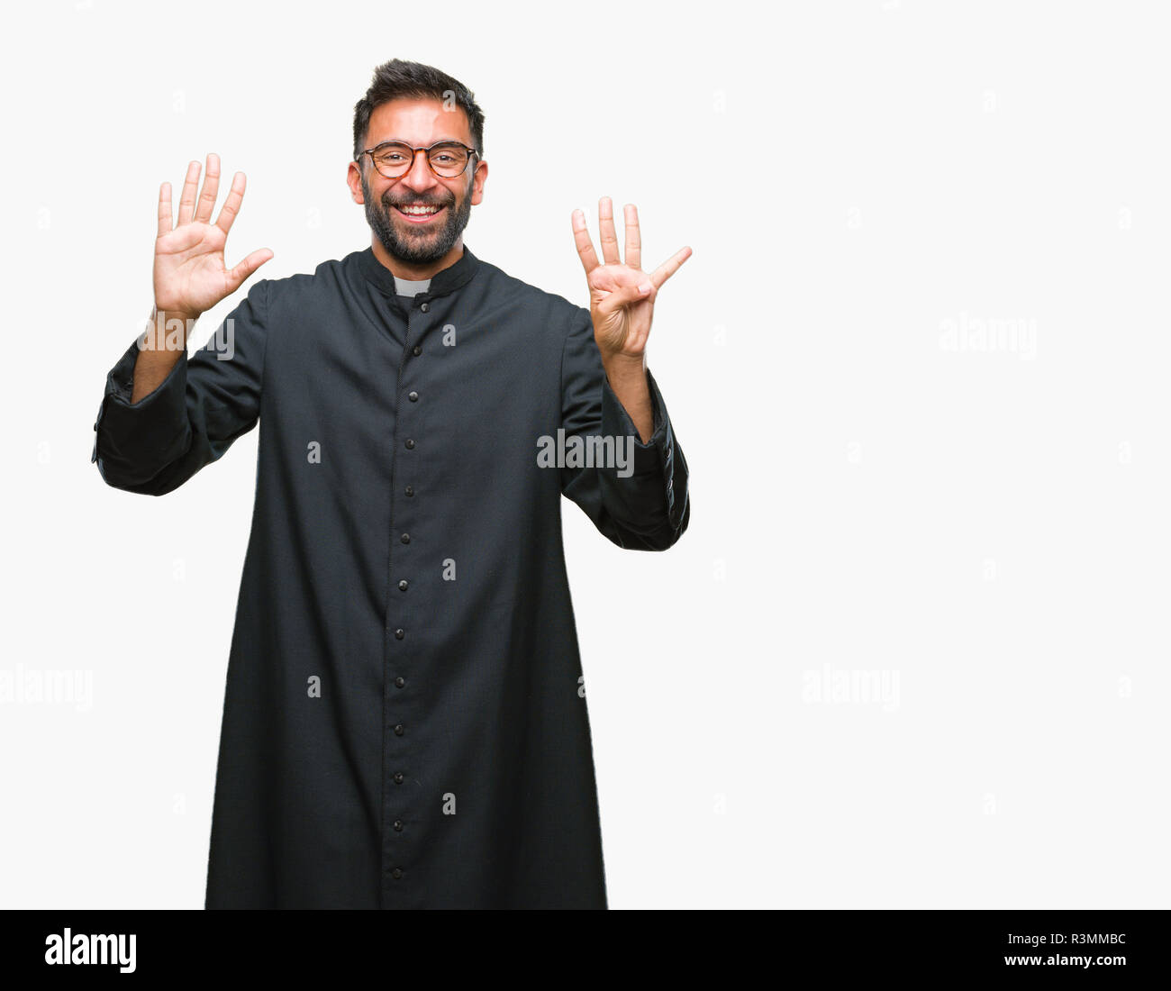Adult hispanic catholic priest man over isolated background showing and ...