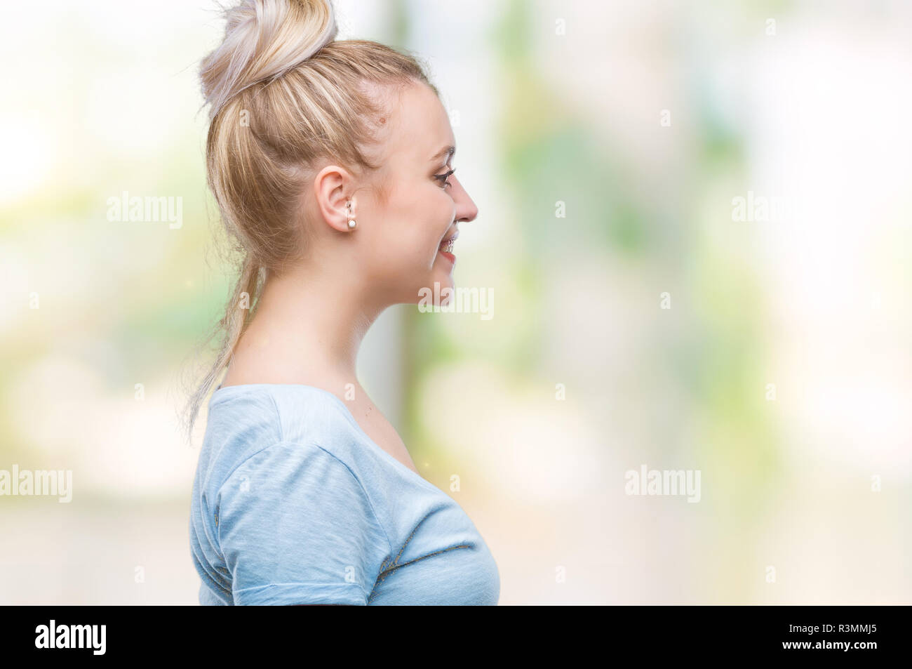 Young blonde woman over isolated background looking to side, relax ...