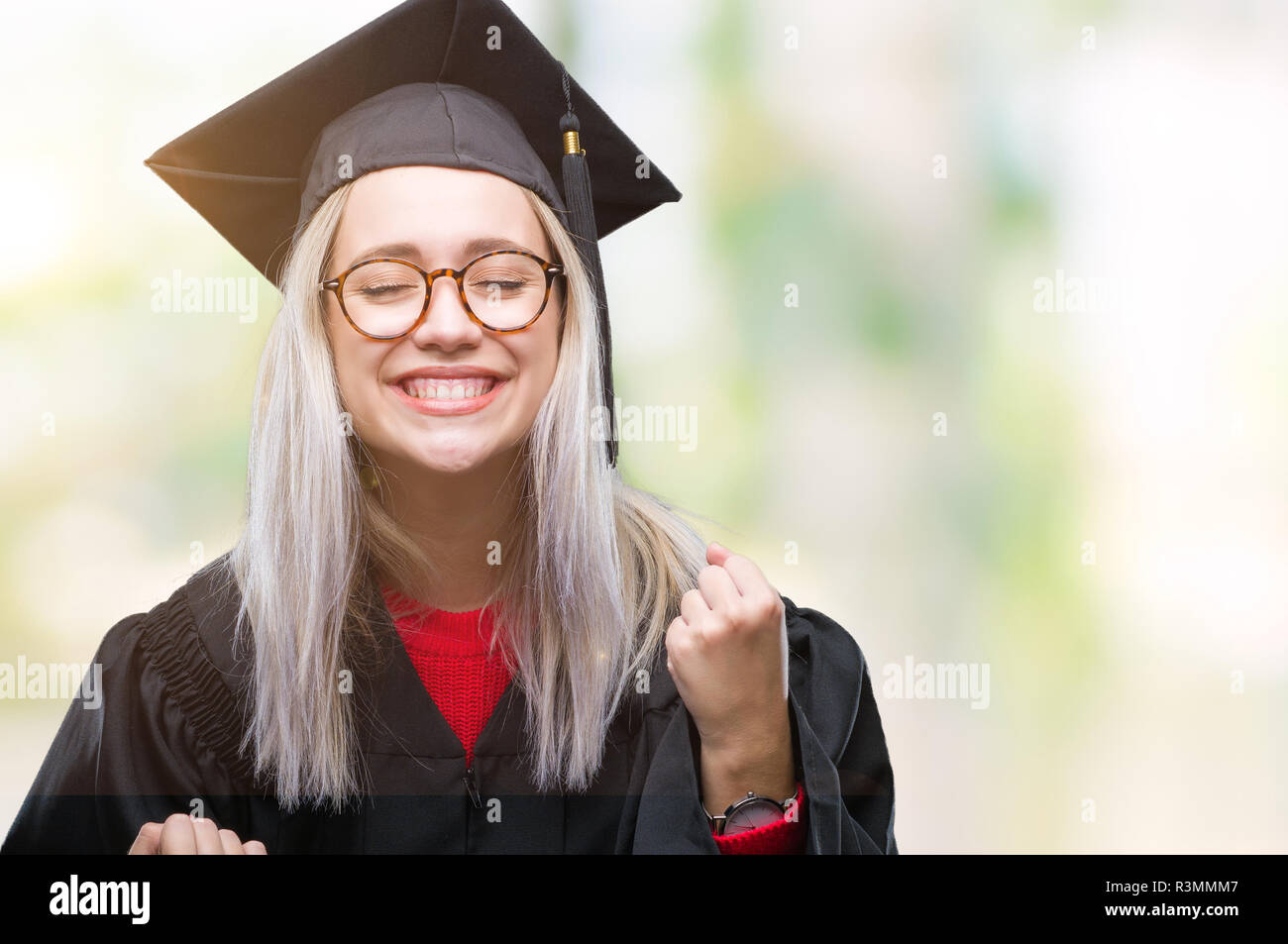 Young blonde woman wearing graduate uniform over isolated background ...