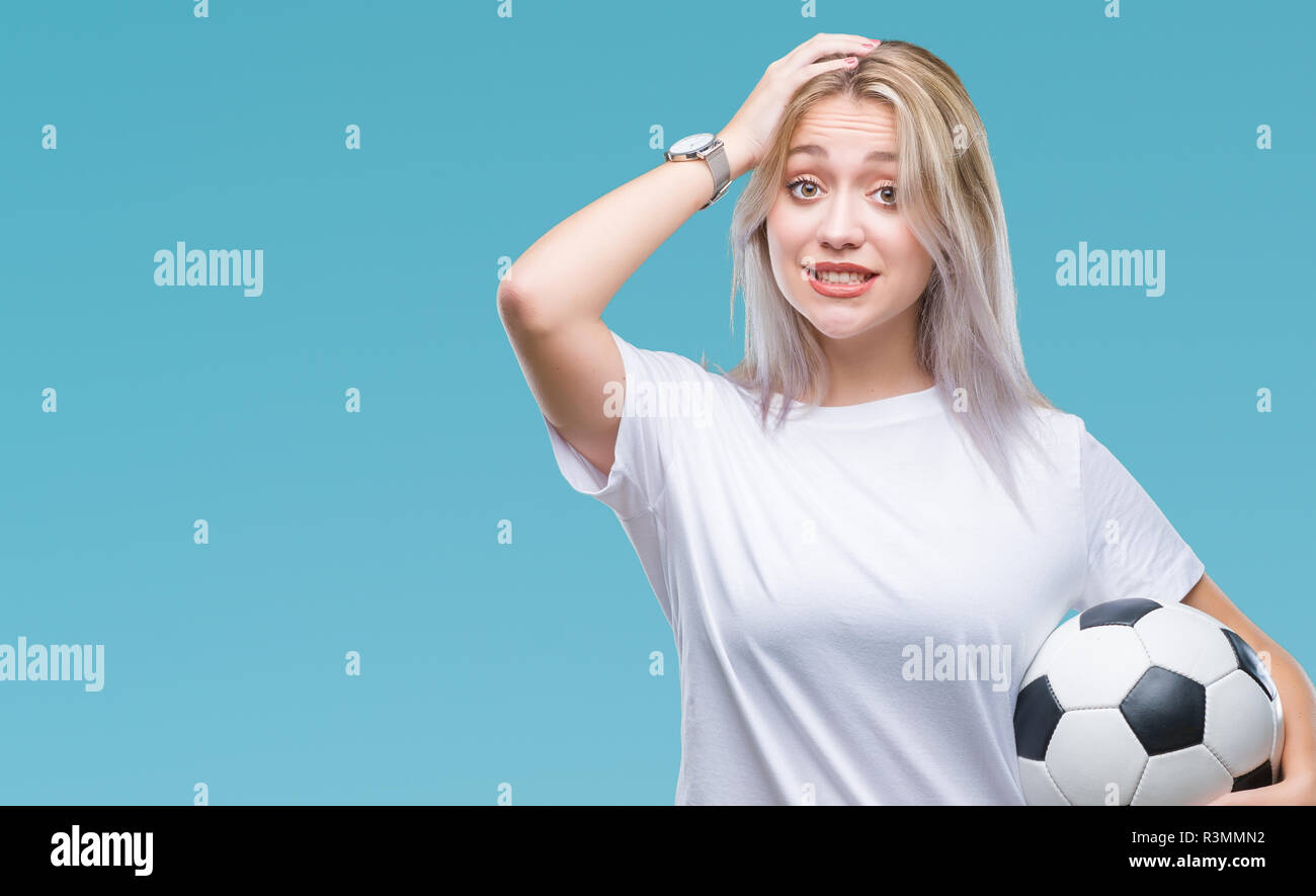 Young blonde woman holding soccer football ball over isolated ...