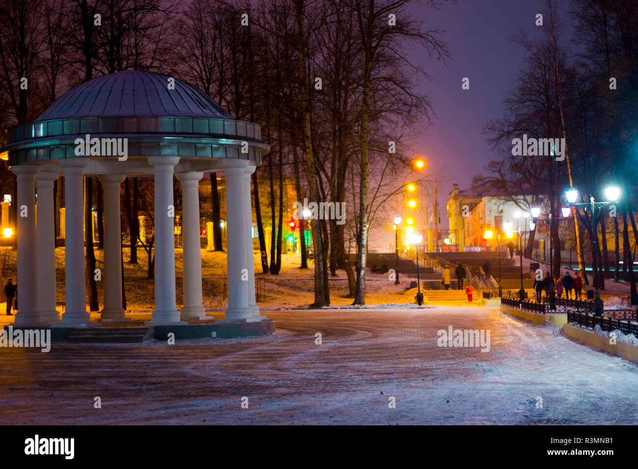 Night winter landscape in the alley of city park. Classical rotunda ...