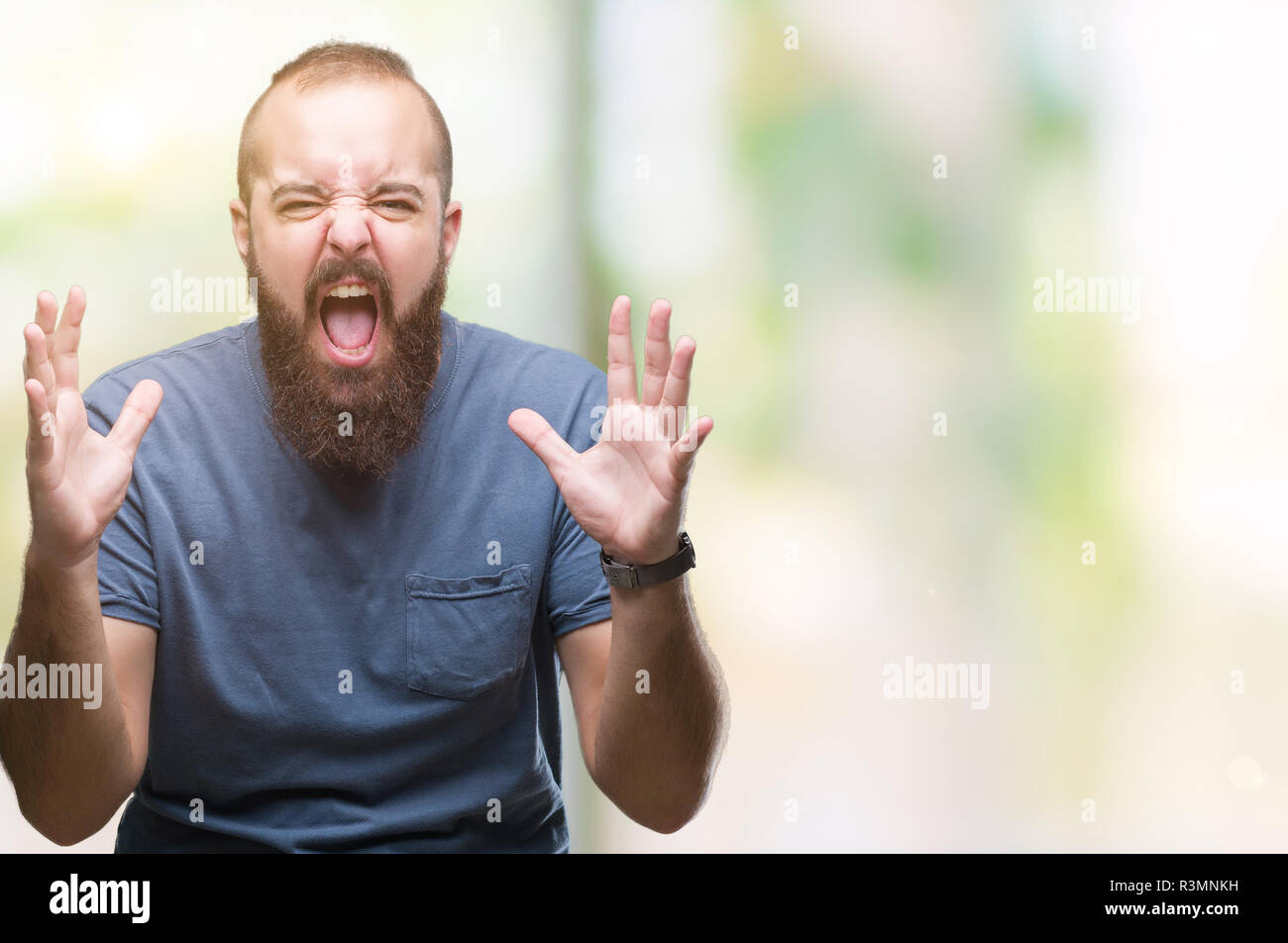 Young caucasian hipster man over isolated background crazy and mad ...