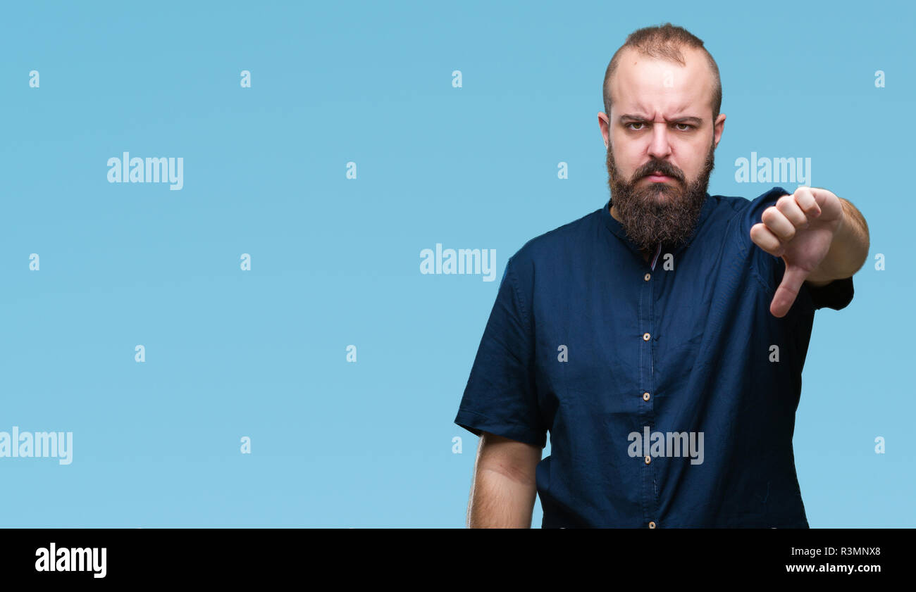 Young caucasian hipster man over isolated background looking unhappy ...