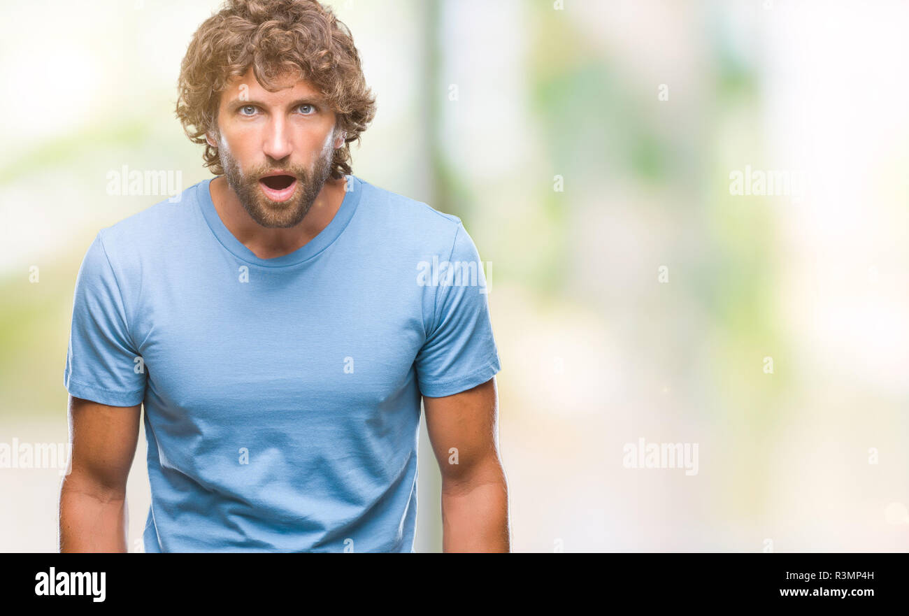 Handsome hispanic model man over isolated background afraid and shocked ...