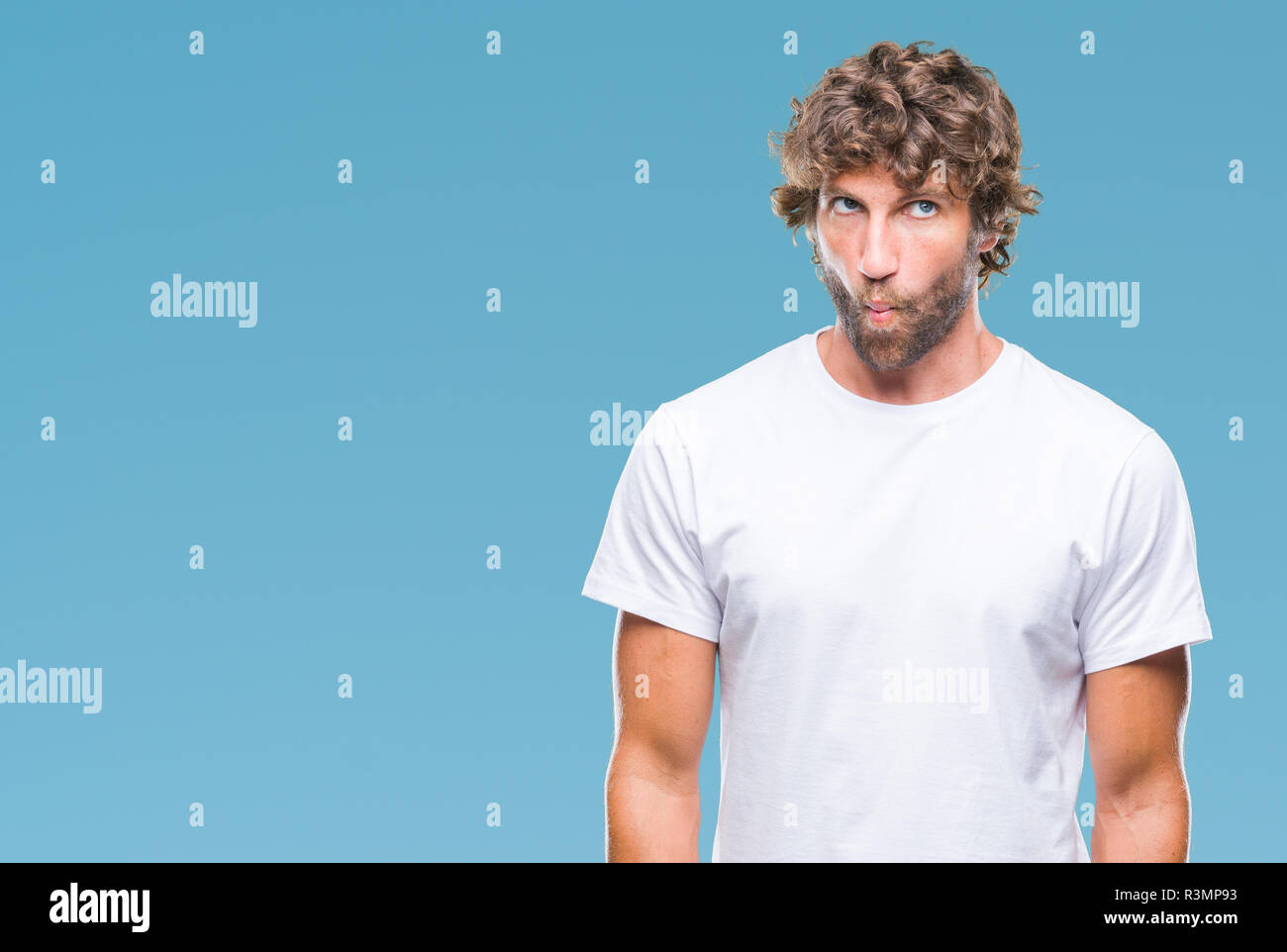 Handsome hispanic model man over isolated background making fish face ...