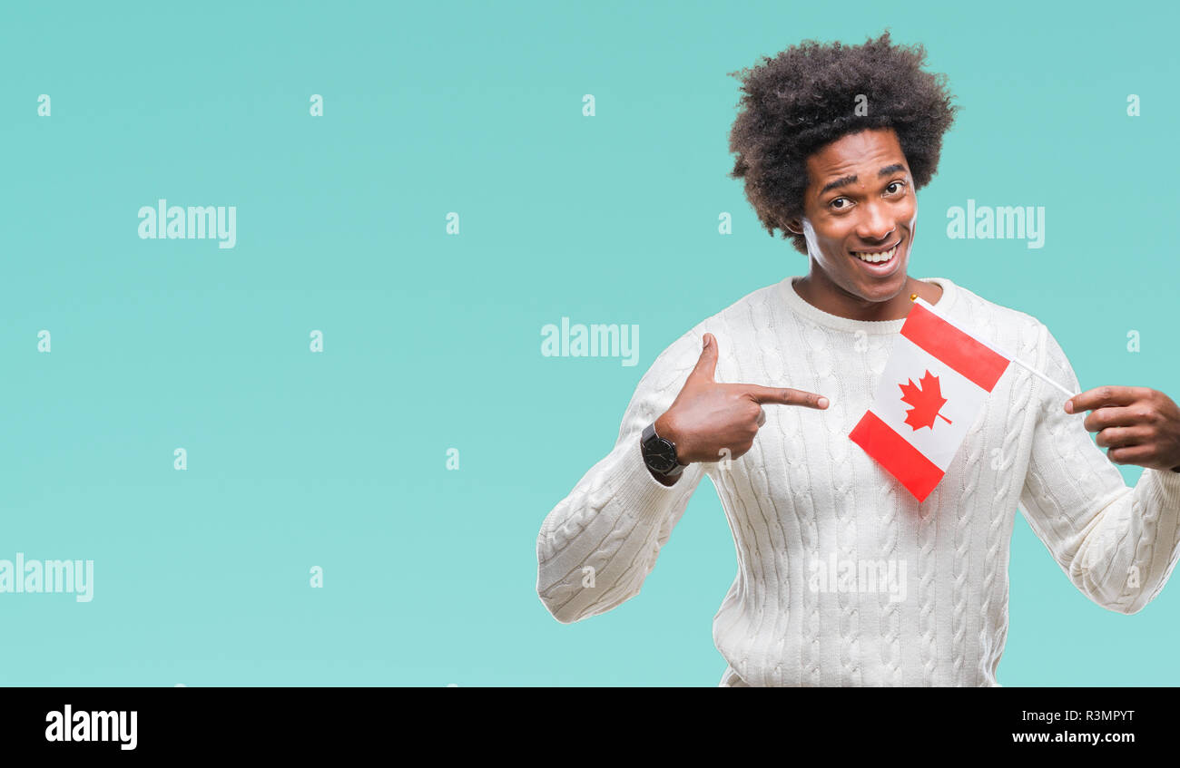 Afro american man flag of Canada over isolated background very happy ...