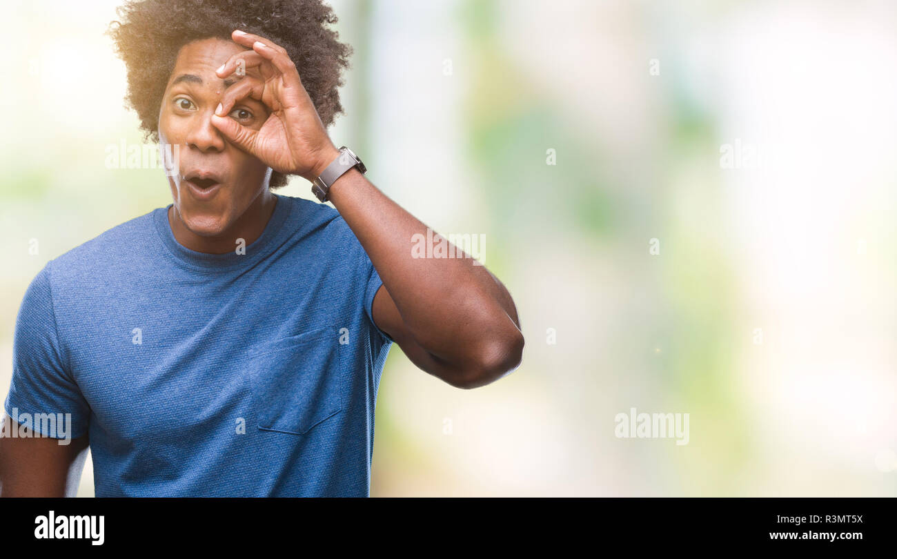 Afro american man over isolated background doing ok gesture shocked ...