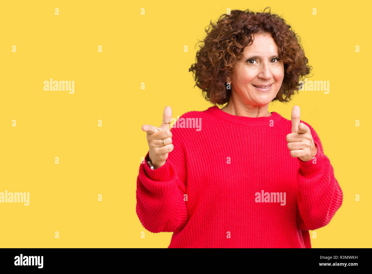 Beautiful middle ager senior woman red winter sweater over isolated ...