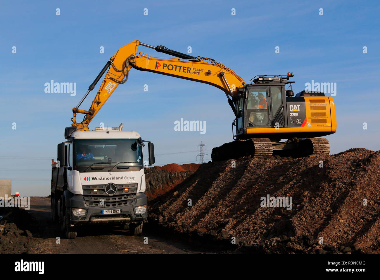 A Caterpillar 320E loading trucks on the FARRRS link road in Rossington ...