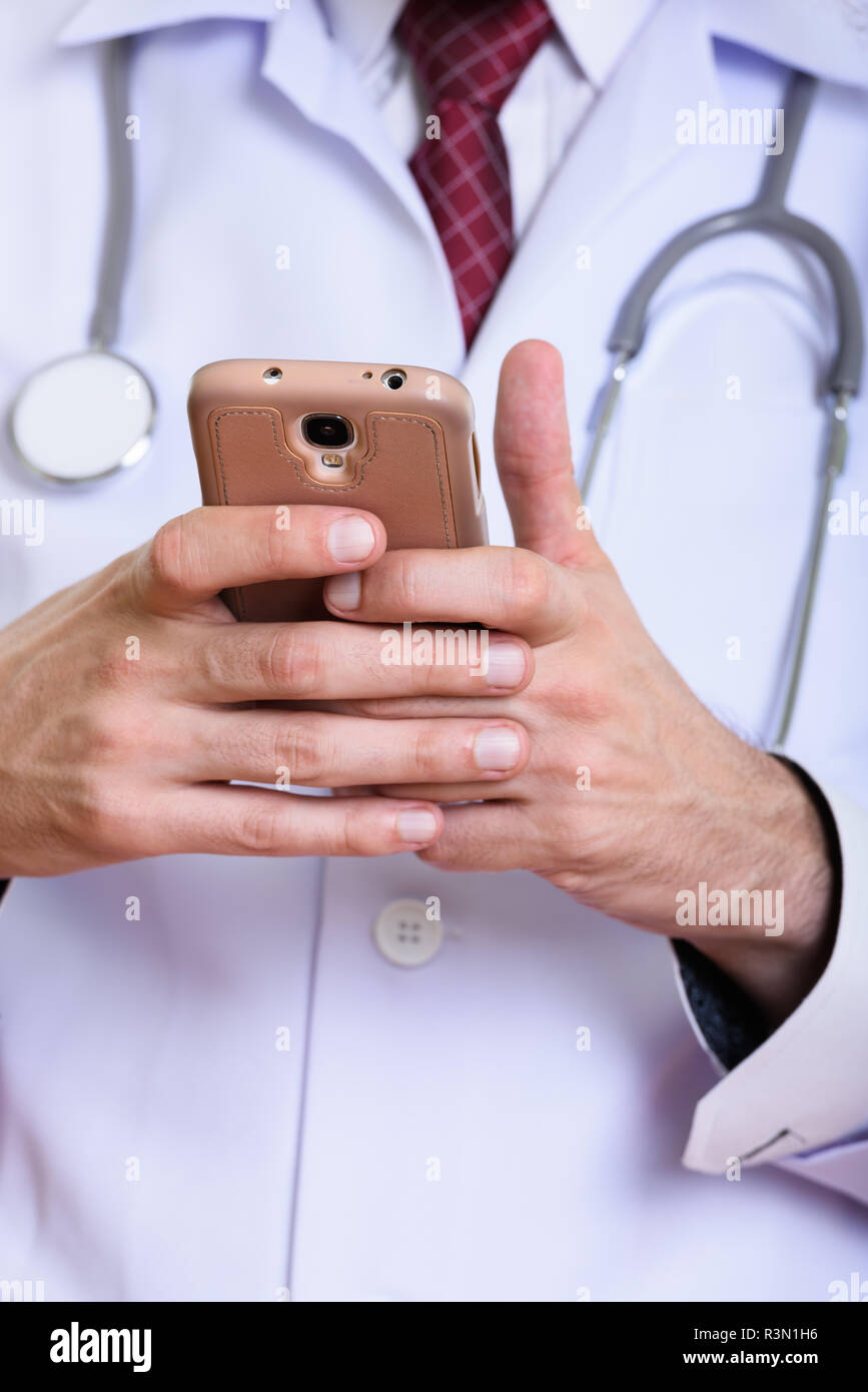 Close up of man doctor using mobile phone Stock Photo - Alamy