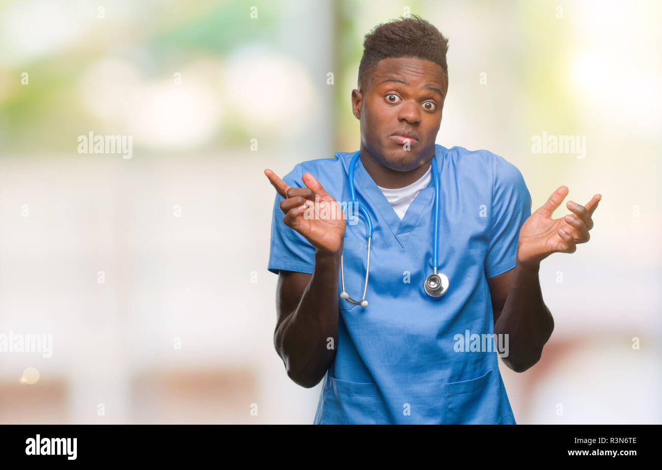 Young african american doctor man over isolated background wearing ...