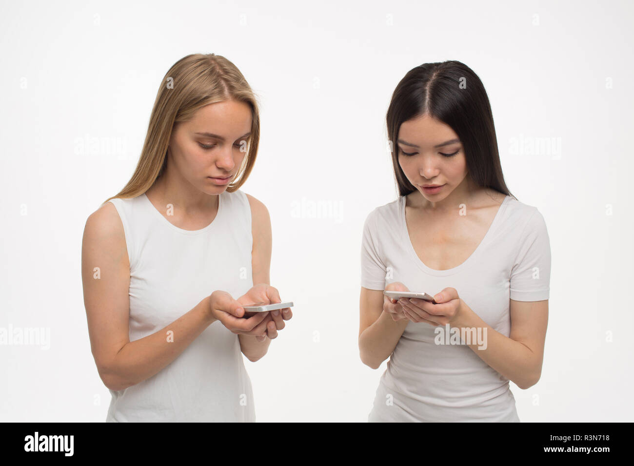 Two women dependence on smartphone Stock Photo - Alamy