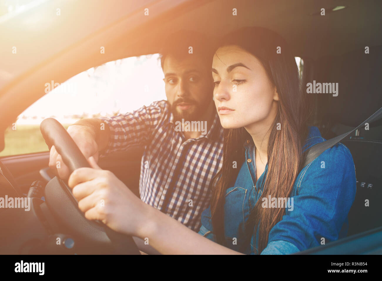 Driving test. Young serious woman driving car feeling inexperienced ...