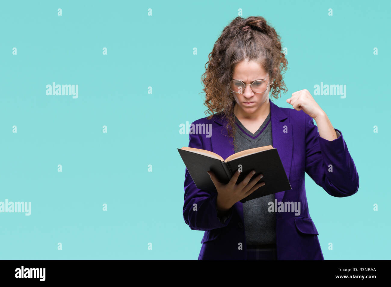 Young brunette student girl wearing school uniform reading a book over ...