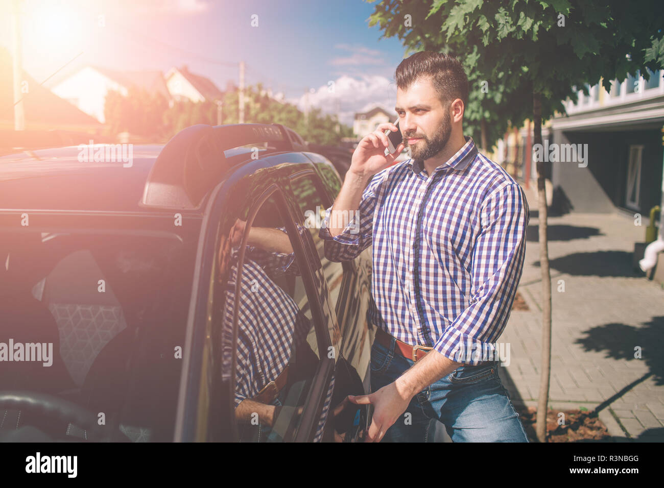 A young man on the background of car Stock Photo - Alamy