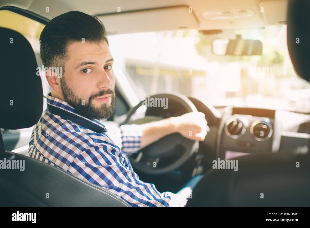 Handsome elegant serious man drives a car Stock Photo - Alamy