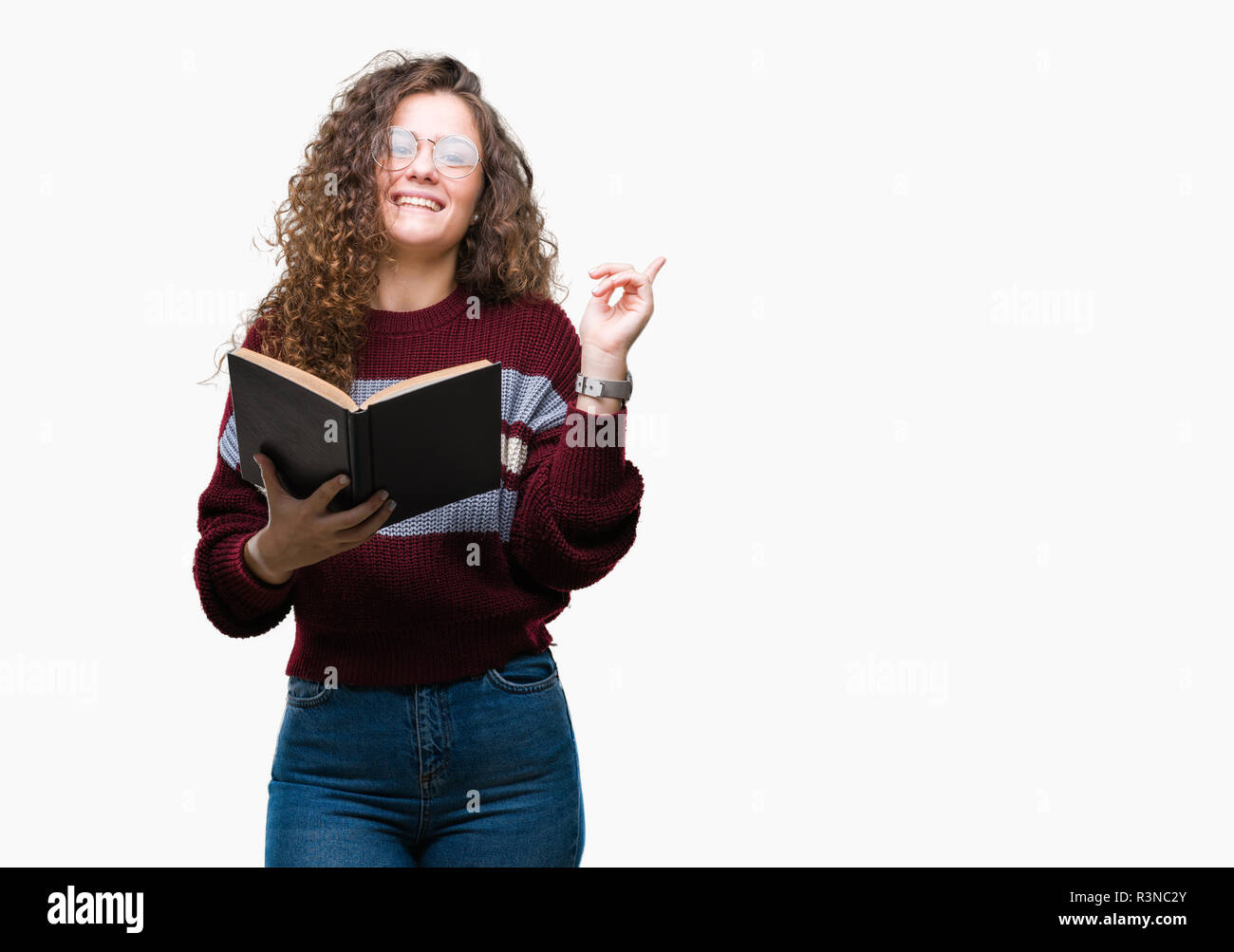 Young brunette girl reading a book wearing glasses over isolated ...
