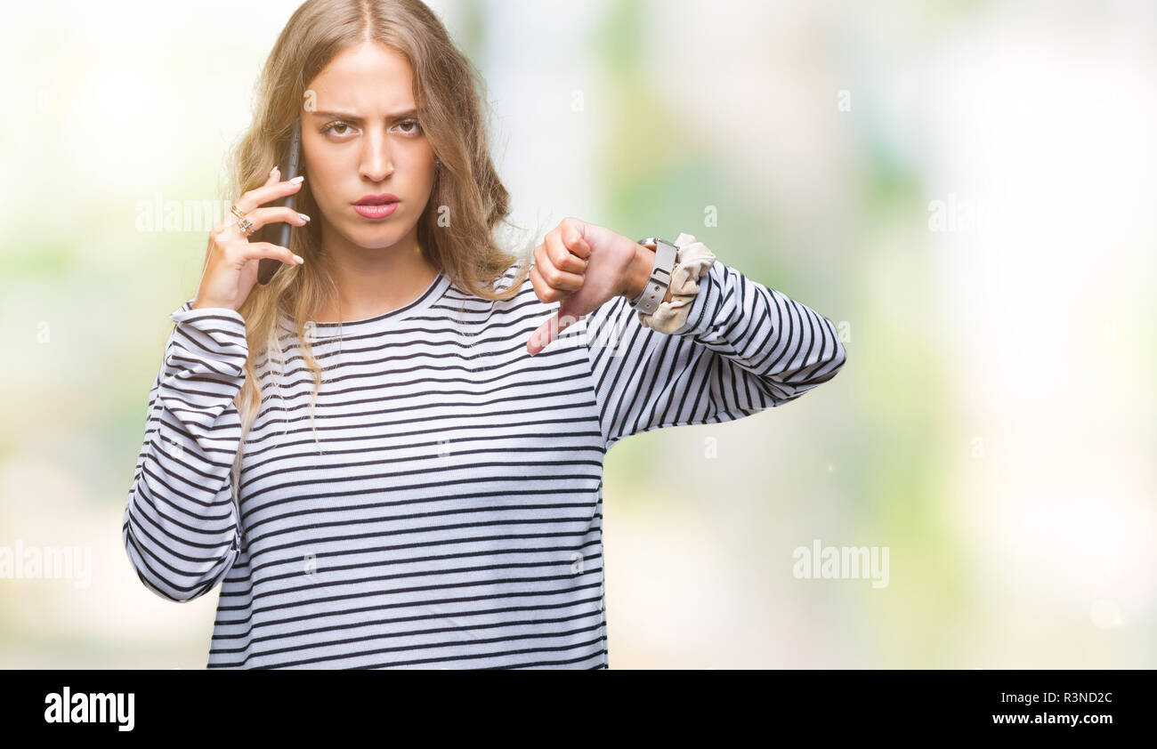 Beautiful young blonde woman talking on smarpthone over isolated ...