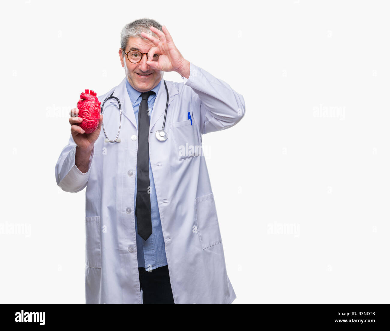 Handsome senior cardiologist doctor man holding heart over isolated ...