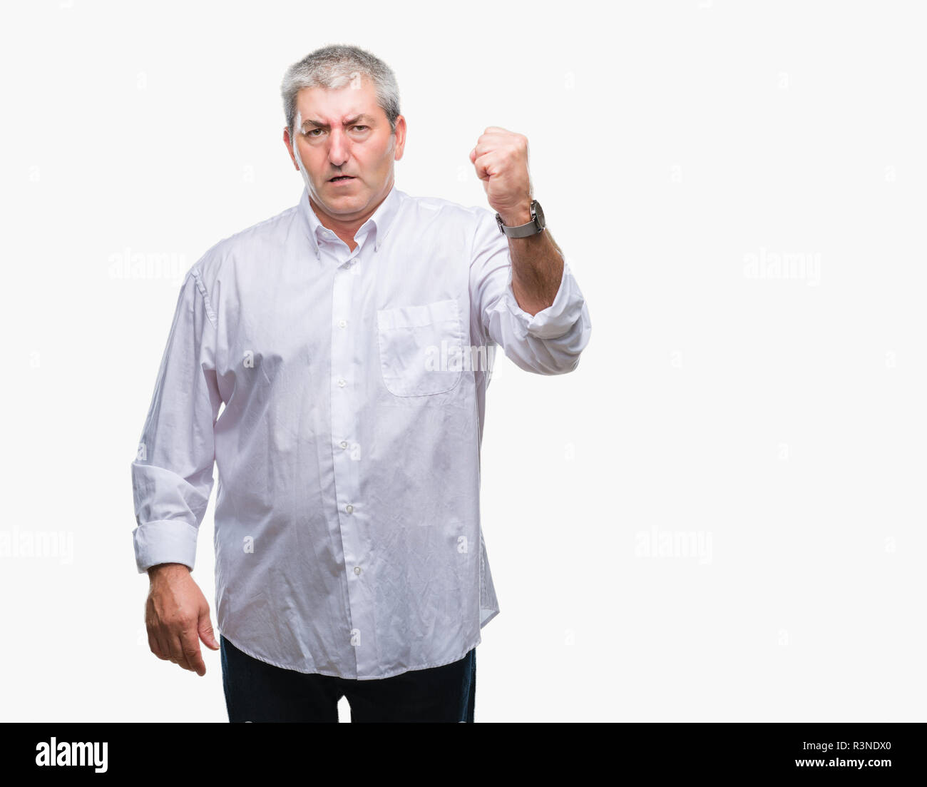 Handsome senior man over isolated background angry and mad raising fist ...