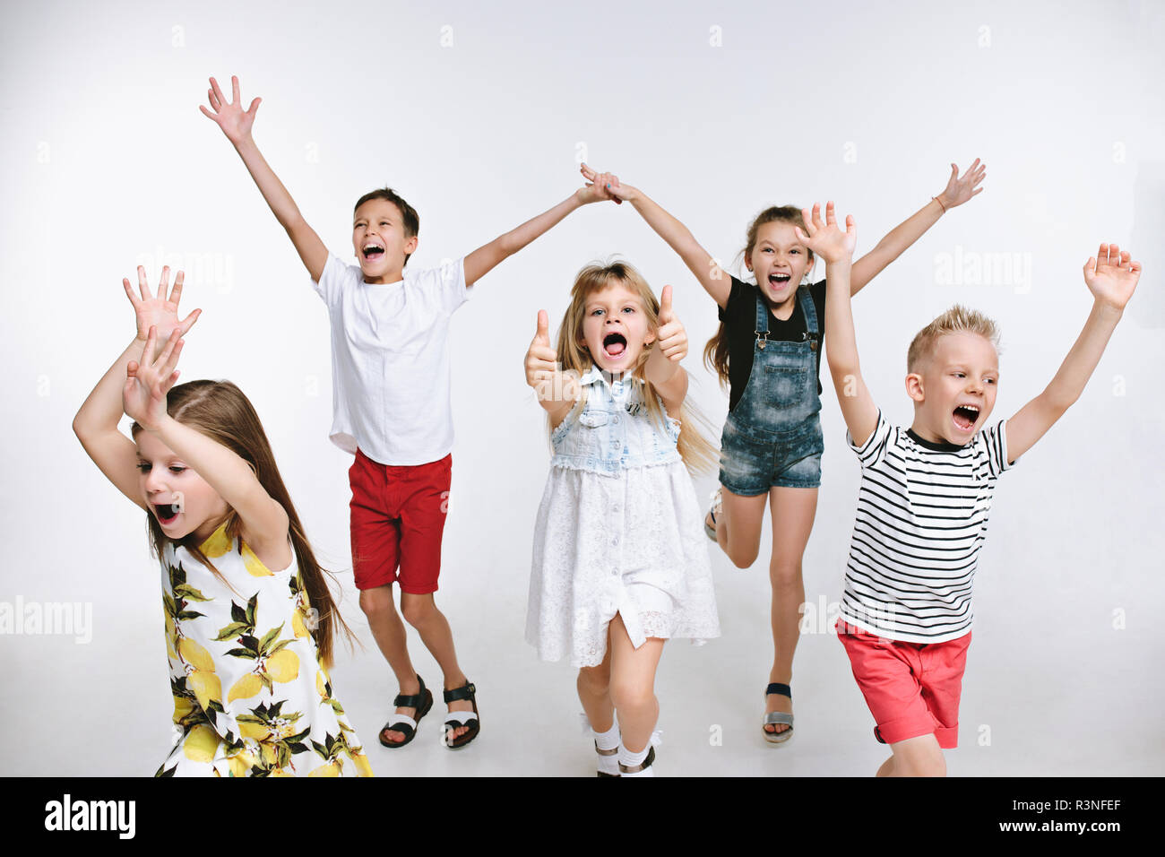 Group of fashion cute preschooler kids friends running together and ...