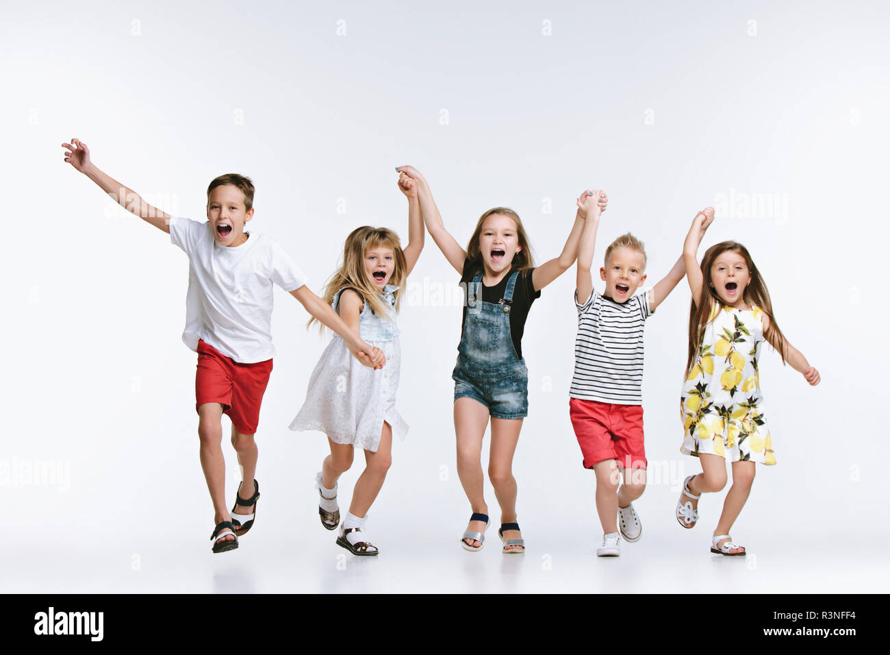Group of fashion cute preschooler kids friends running together and ...